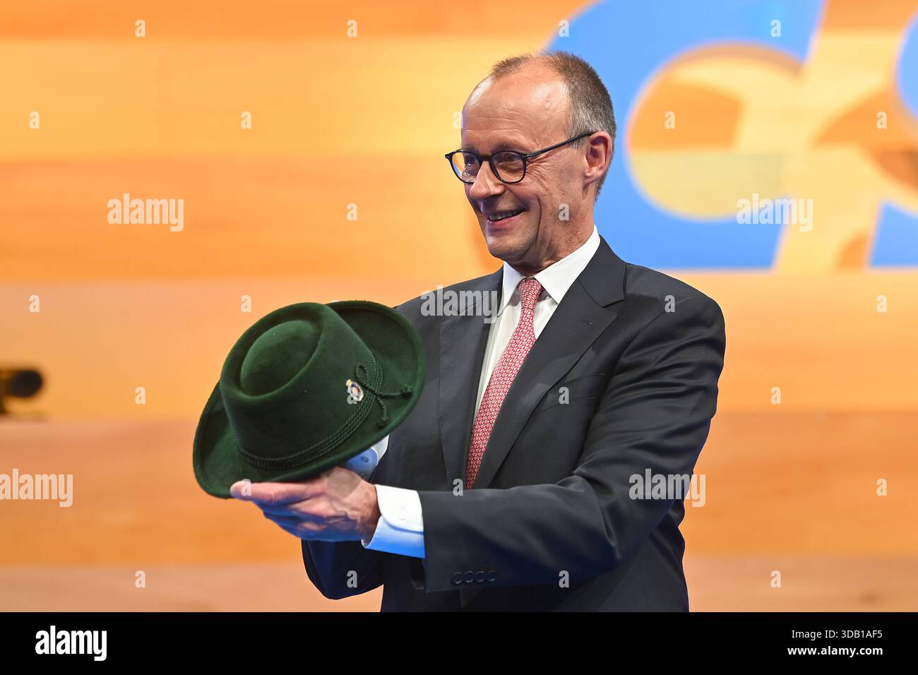 Chancellor Friedrich MERZ (CDU) receives a traditional Bavarian hat as ...