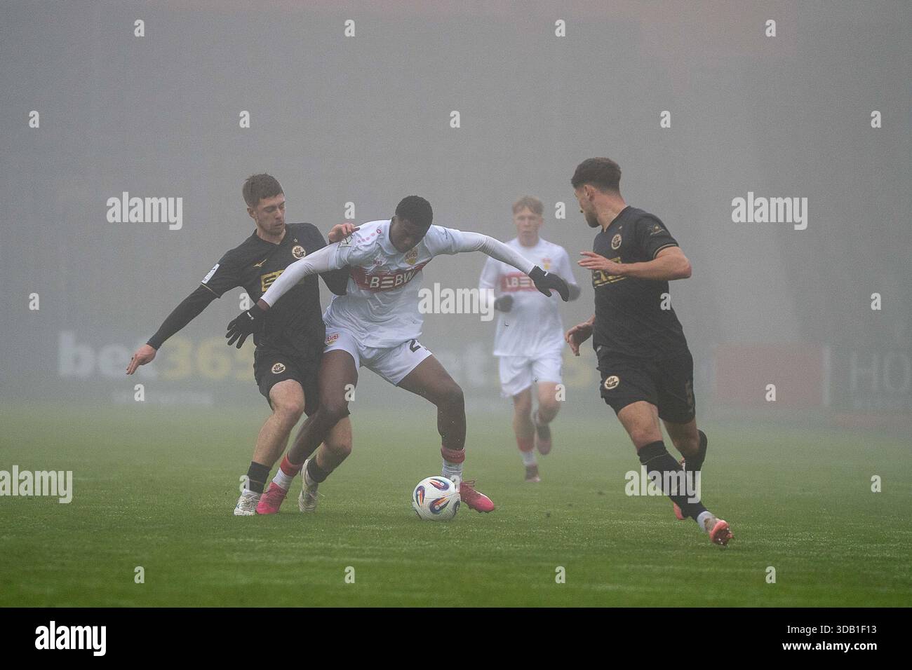 Tackle between Mansour Ouro-Tagba (Stuttgart II, #27) and Jonas Dirkner ...