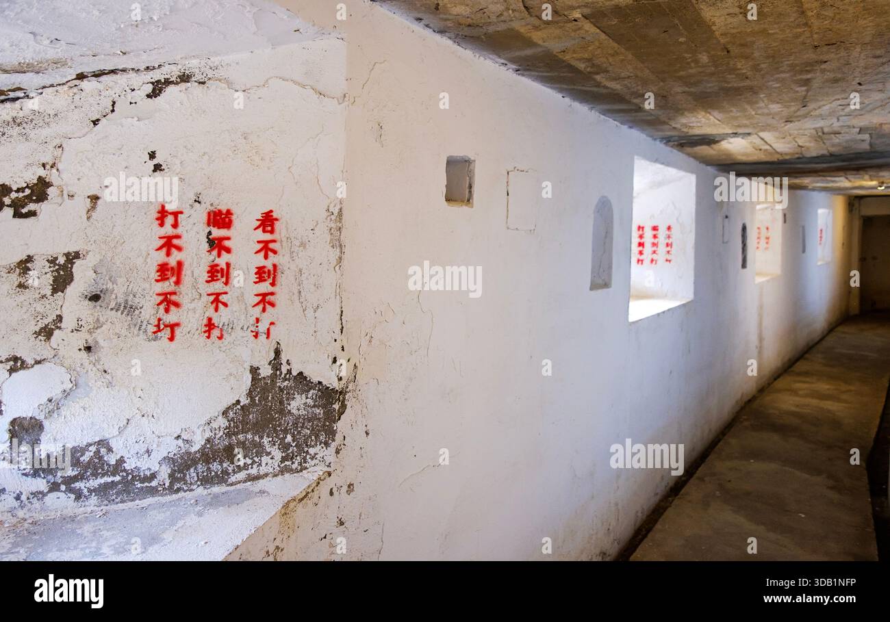 Red military slogans stenciled on the walls of a concrete defensive ...