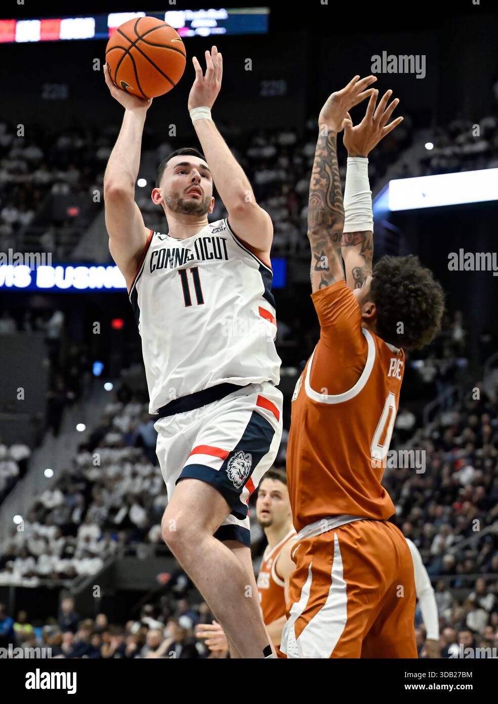 UConn forward Alex Karaban (11) shoots over Texas guard Jordan Pope (0 ...