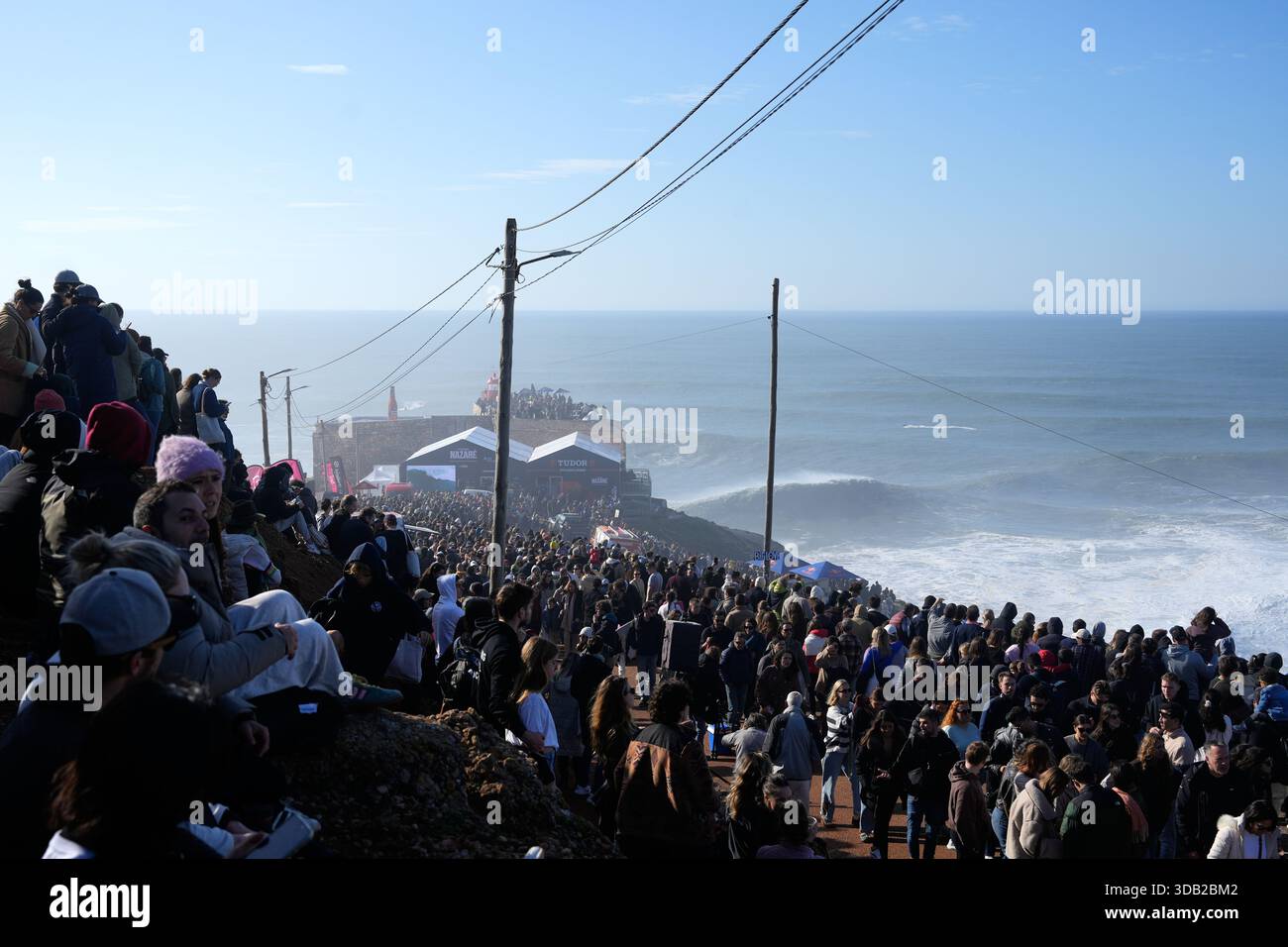 Thousands gather atop the cliffs overlooking the beach to watch the ...