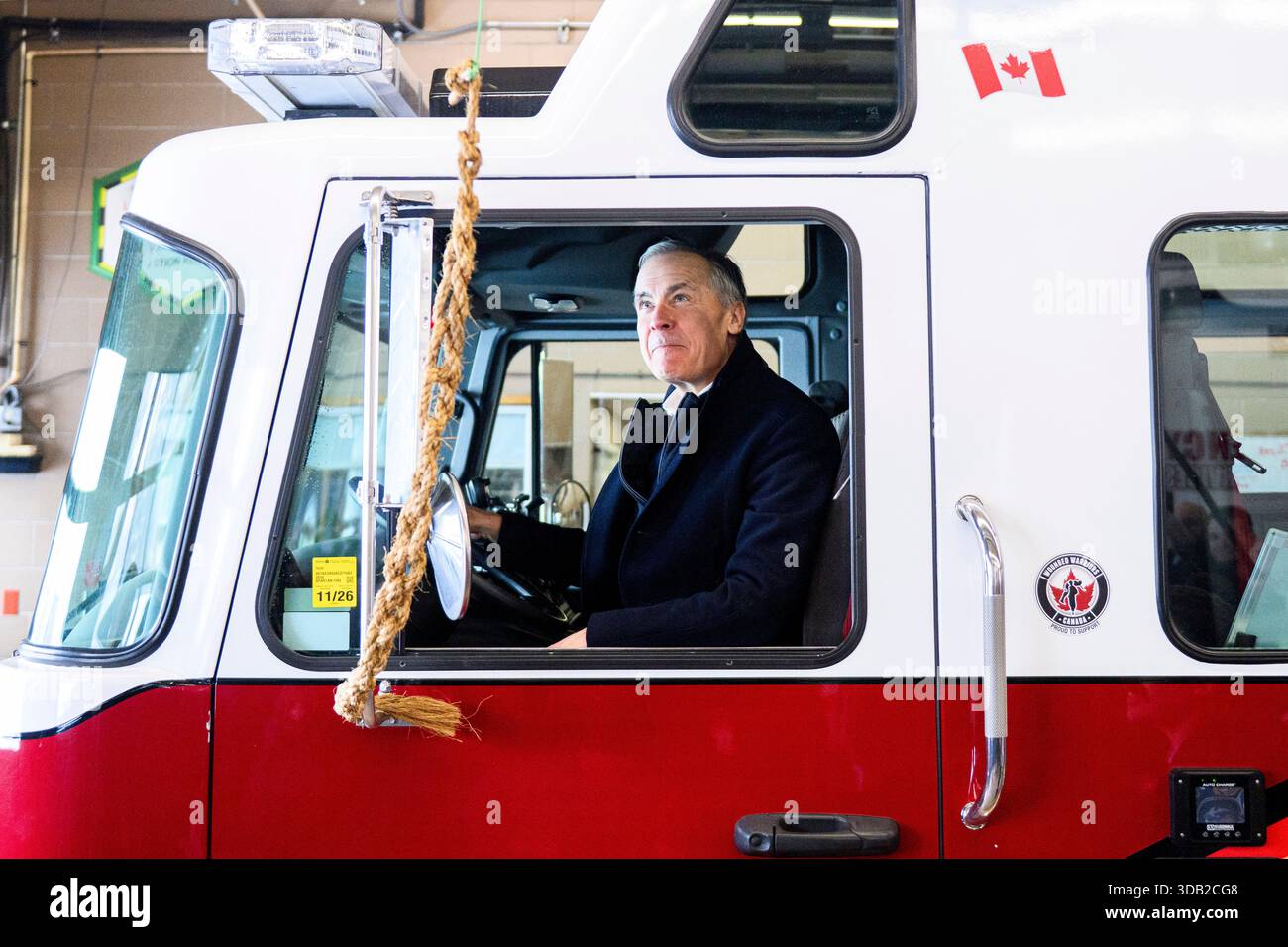 Prime Minister Mark Carney sits in the drivers seat of a firetruck ...