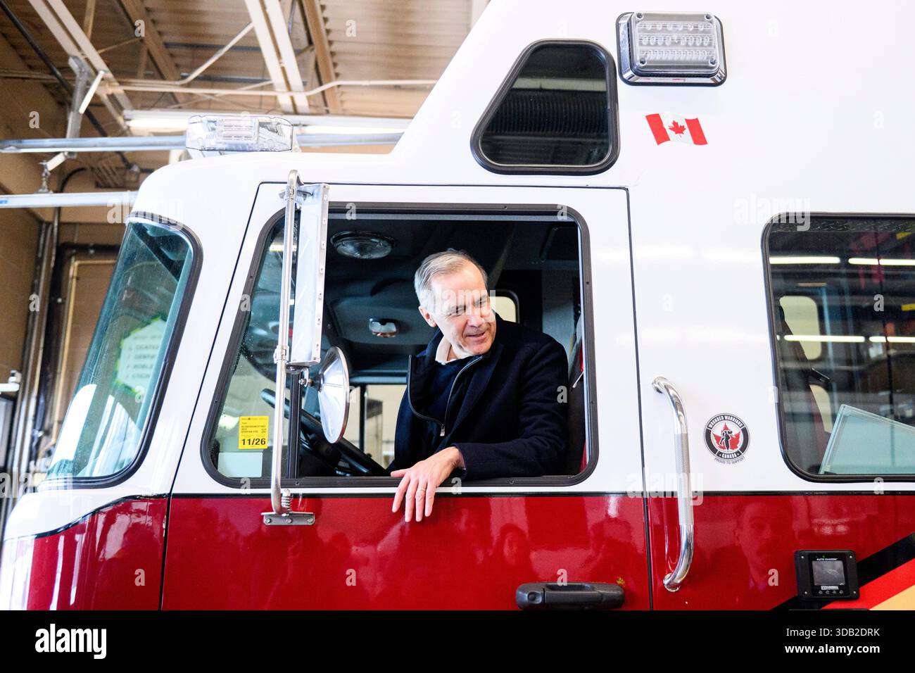 Prime Minister Mark Carney sits in the drivers seat of a firetruck ...