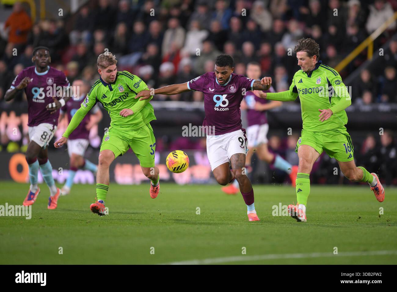 Burnley's Lyle Foster (centre) battle for the ball with Fulham's Emile ...