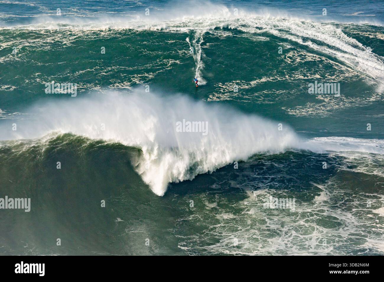 A surfer rides a towering wave during the Tudor Nazaré Big Wave ...