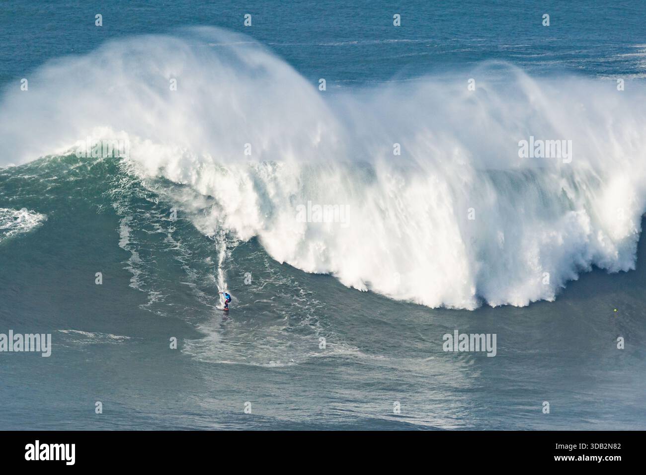 A surfer rides a towering wave during the Tudor Nazaré Big Wave ...