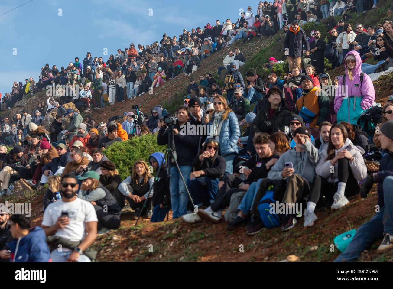 Spectators gather on the hillside to watch the Tudor Nazaré Big Wave ...