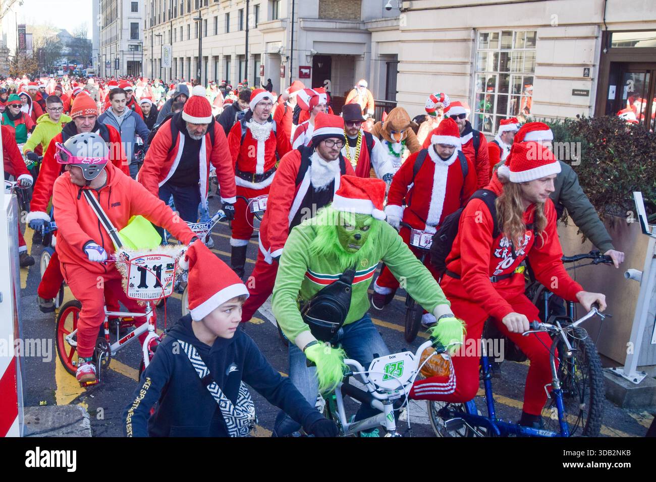 A participant wears a Grinch costume as hundreds of cyclists dressed as Santa Claus and other ...