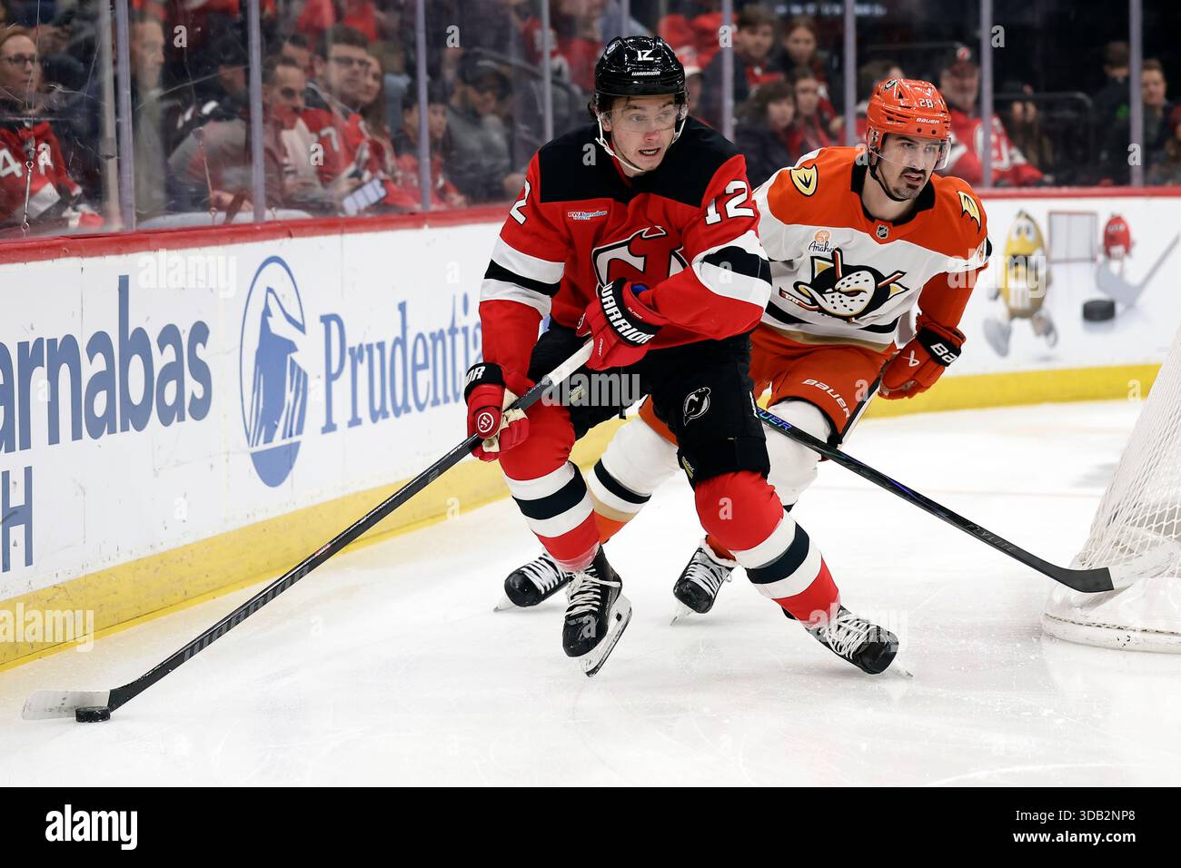 New Jersey Devils center Cody Glass (12) controls the puck past Anaheim ...