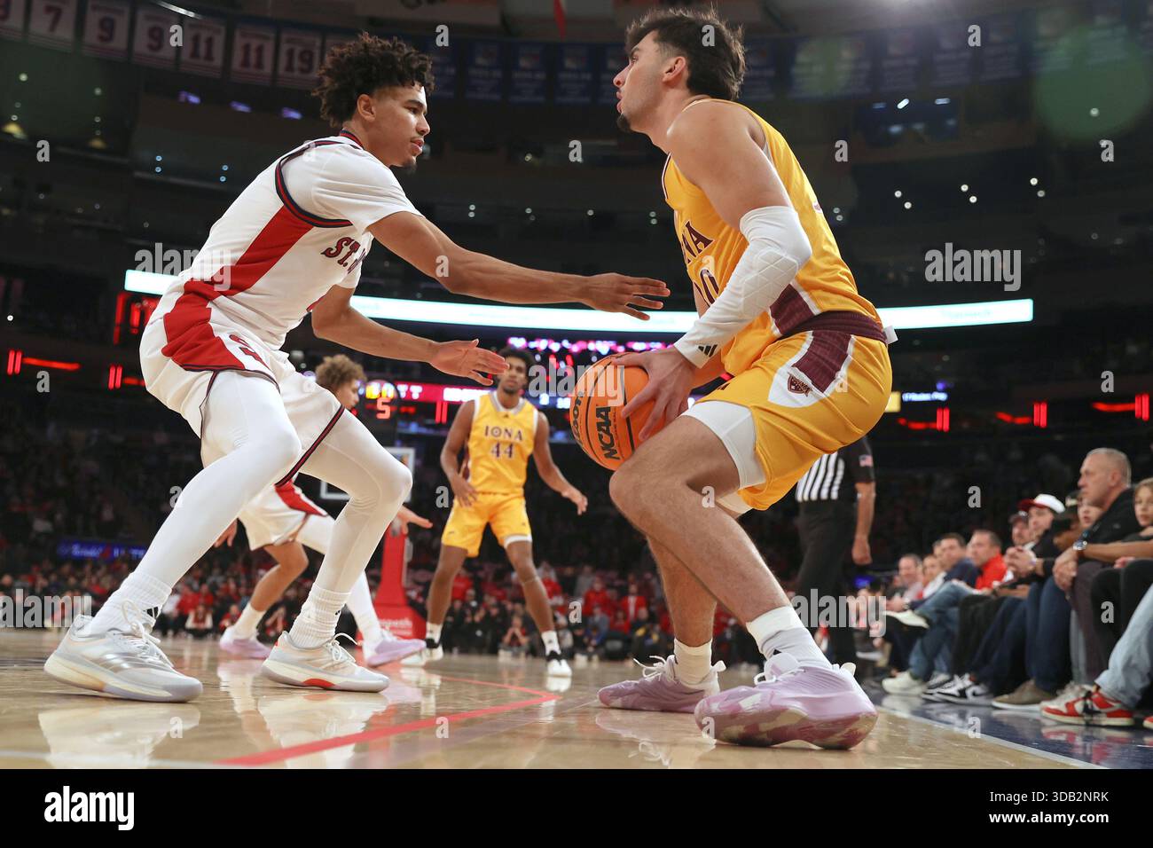 Iona forward Toby Harris (30) looks to pass the ball as St. John's ...
