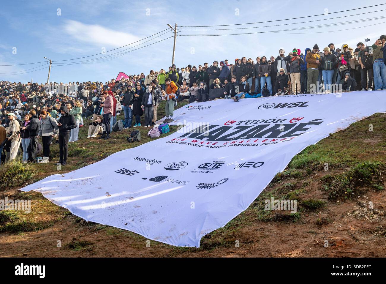December 13, 2025, Nazare, Portugal: Spectators gather on the hillside ...