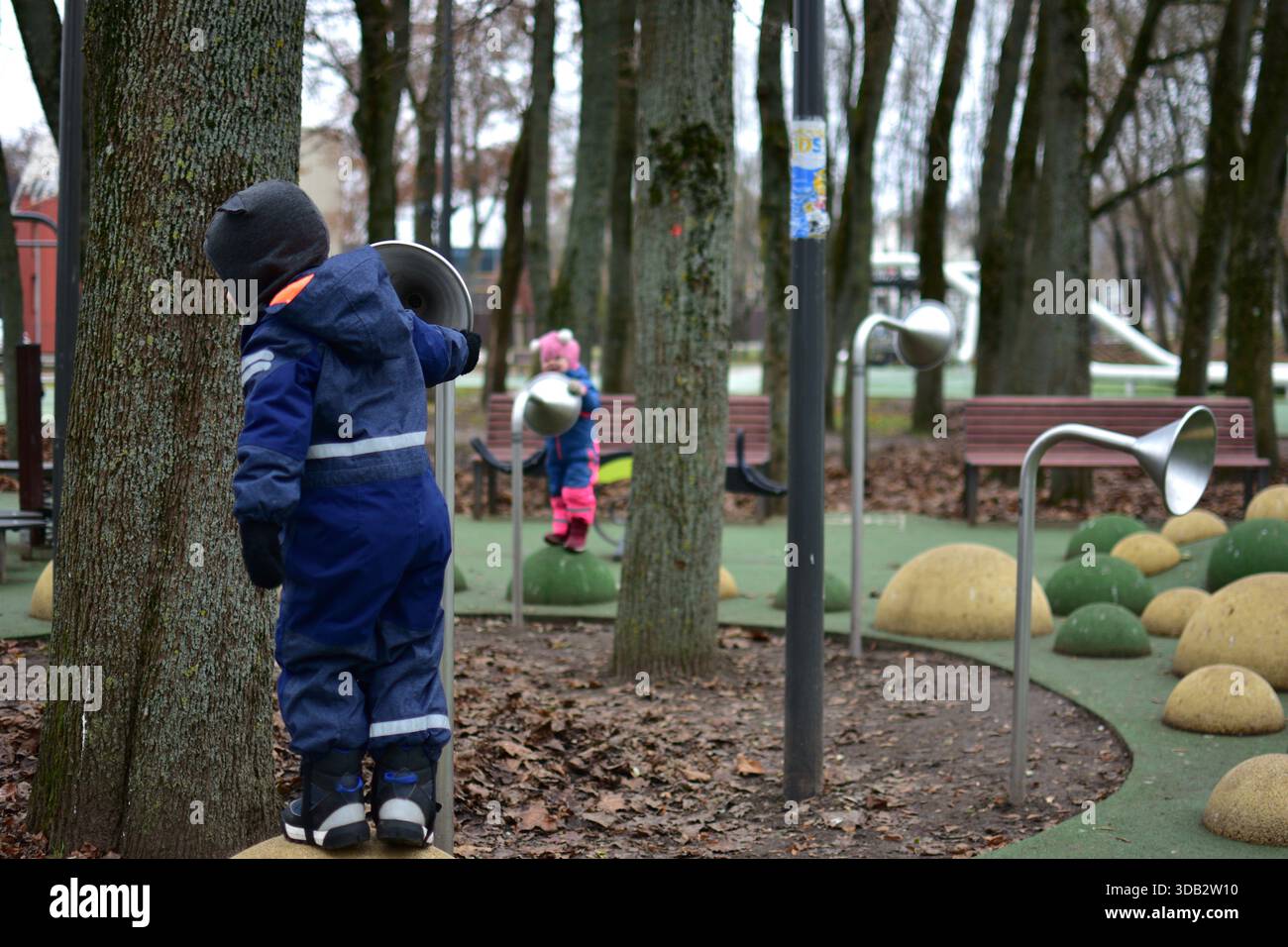 Siblings playing playground toy hi-res stock photography and images - Alamy