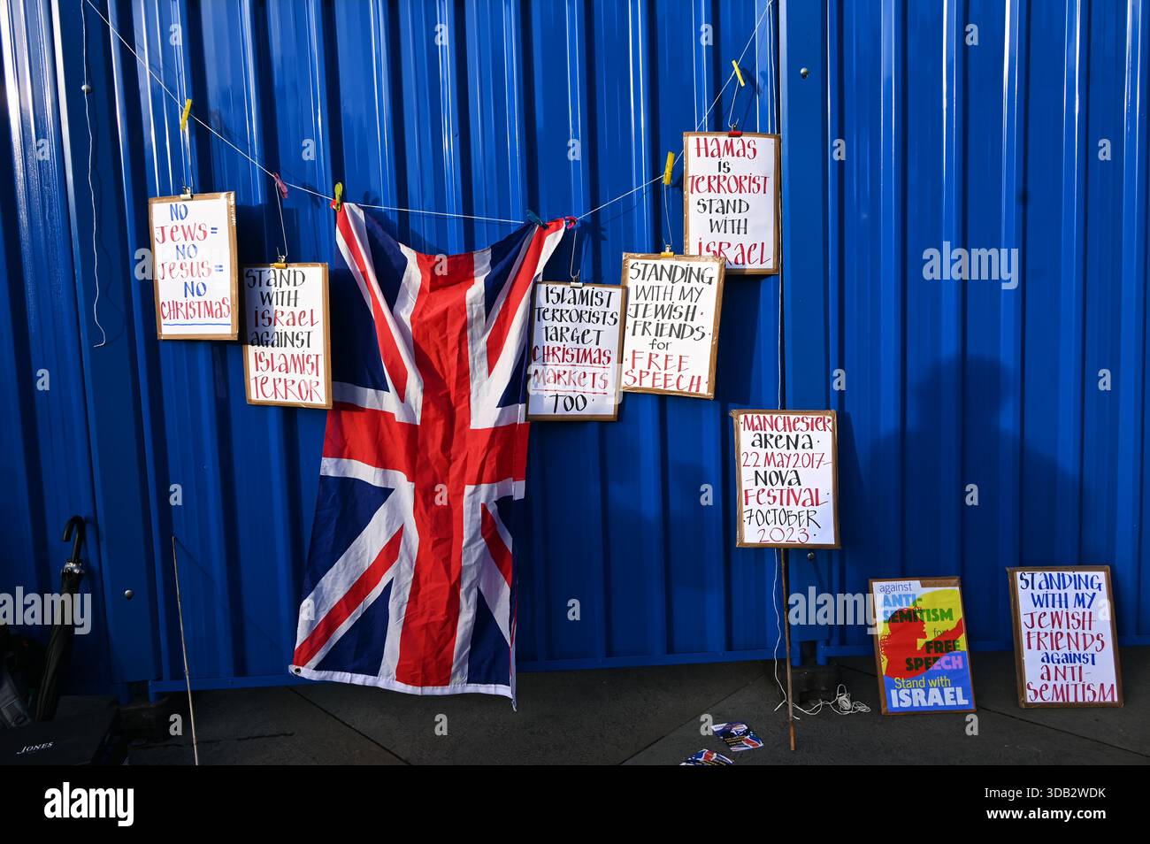 London, England, 13th December 2025: A man holding a palcard written ...