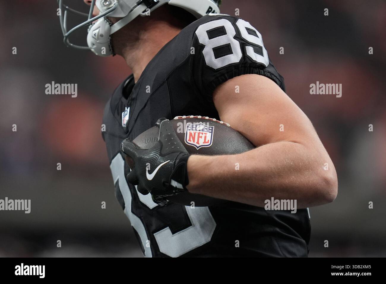 Las Vegas Raiders tight end Brock Bowers carries a football showing the ...