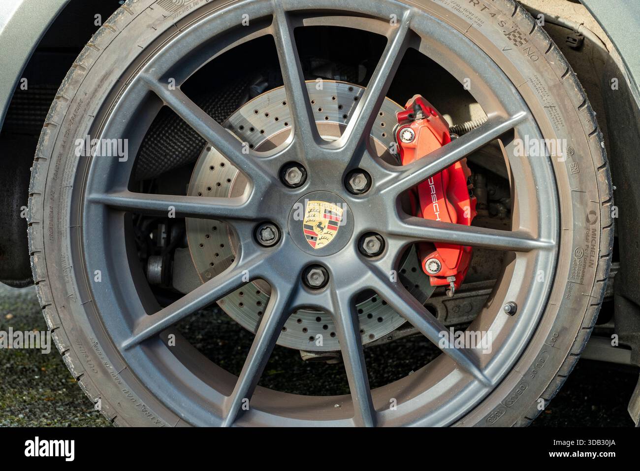 Close-up of Porsche alloy wheel with drilled brake discs and red ...