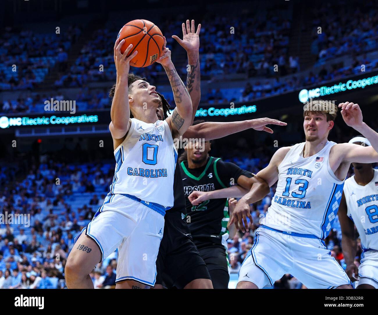 December 13, 2025: North Carolina guard Kyan Evans (0) takes layup in ...