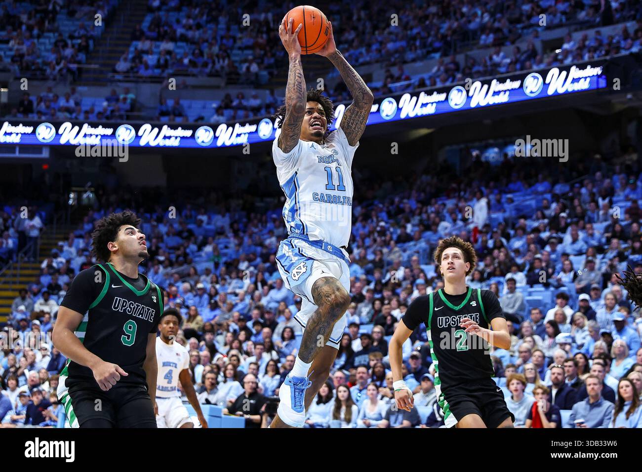 December 13, 2025: North Carolina guard Jonathan Powell (11) goes up ...