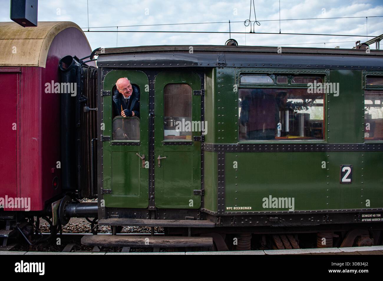 An old man is enjoying the travel on the steam train. For the past ...