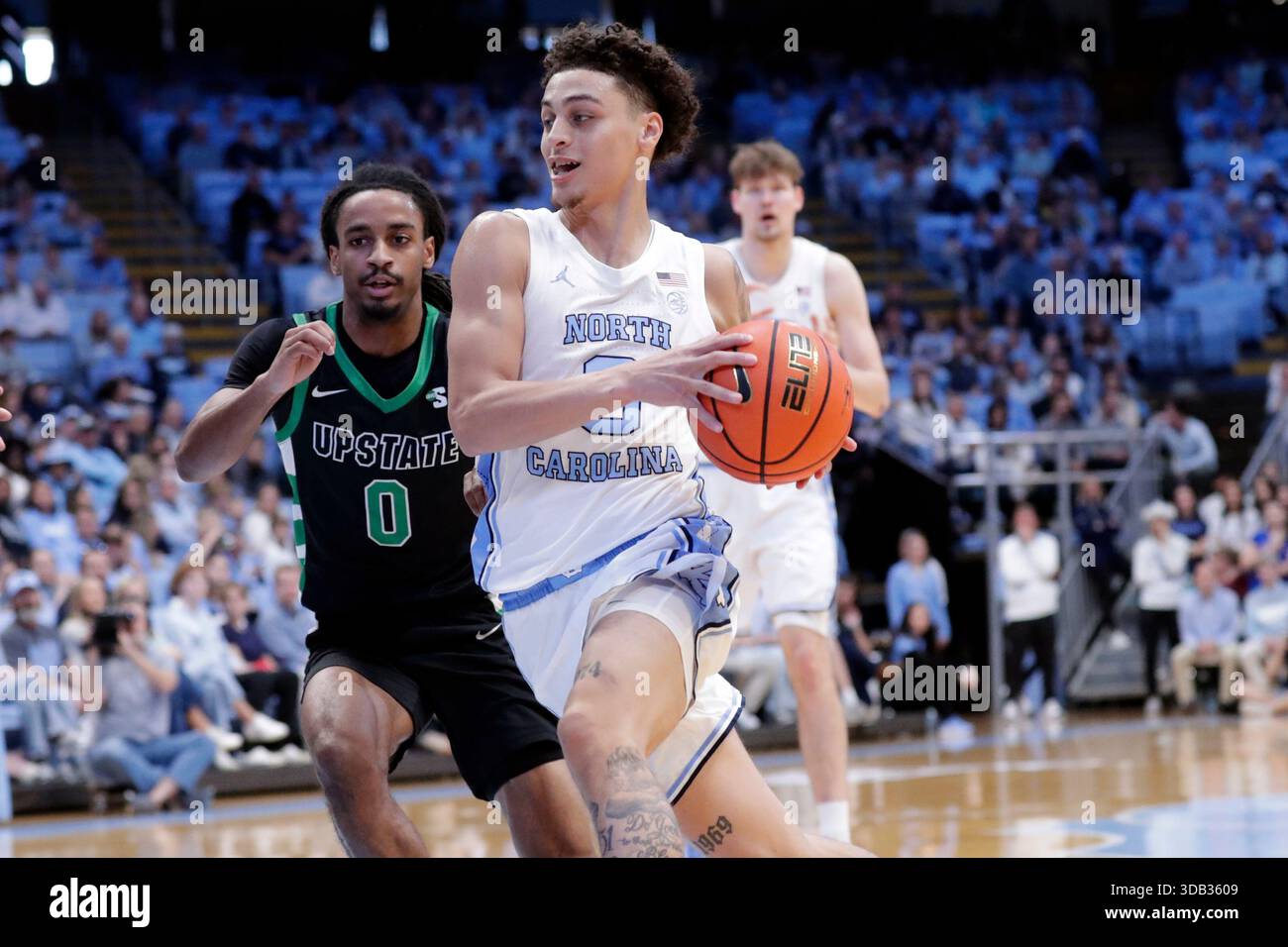 North Carolina guard Kyan Evans, right, drives against USC Upstate ...