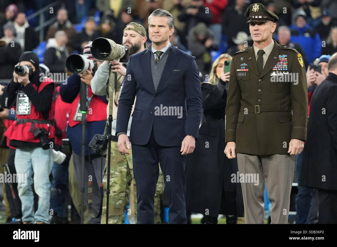 Defense Secretary Pete Hegseth stands on the sidelines before halftime ...