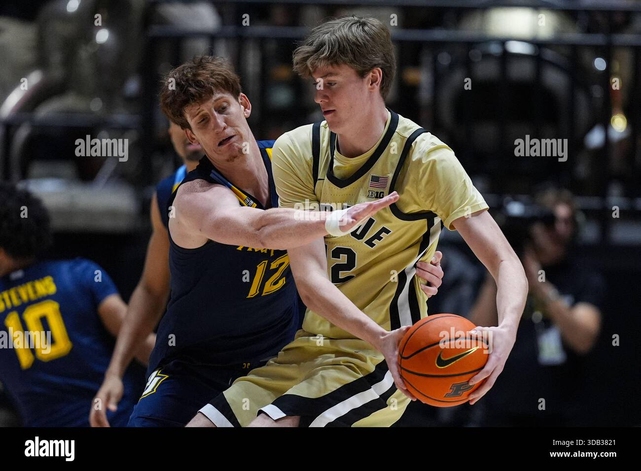 Marquette forward Ben Gold (12) reaches around Purdue center Daniel ...