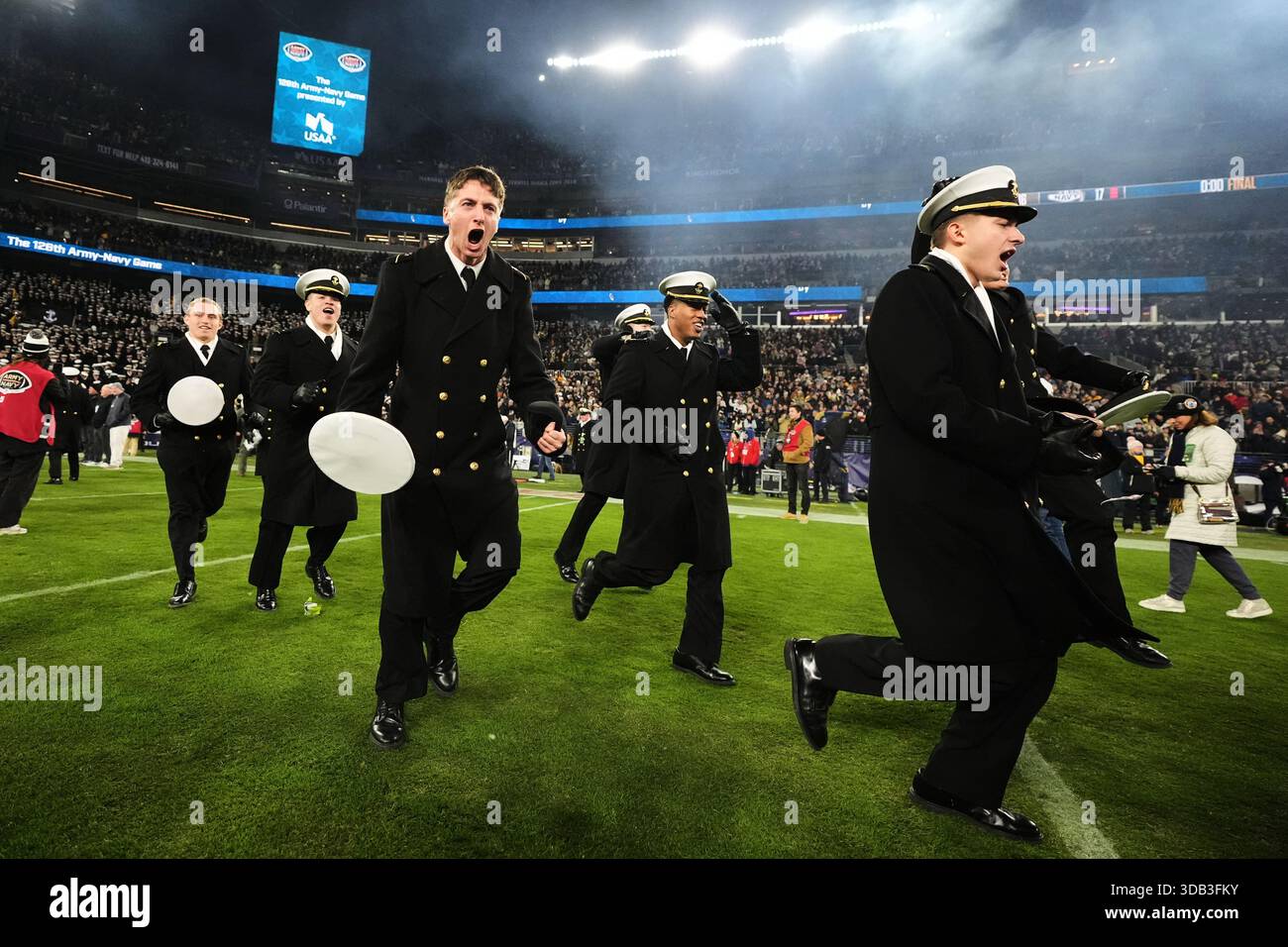 Navy midshipmen storm the field after the team's win over Army in an ...
