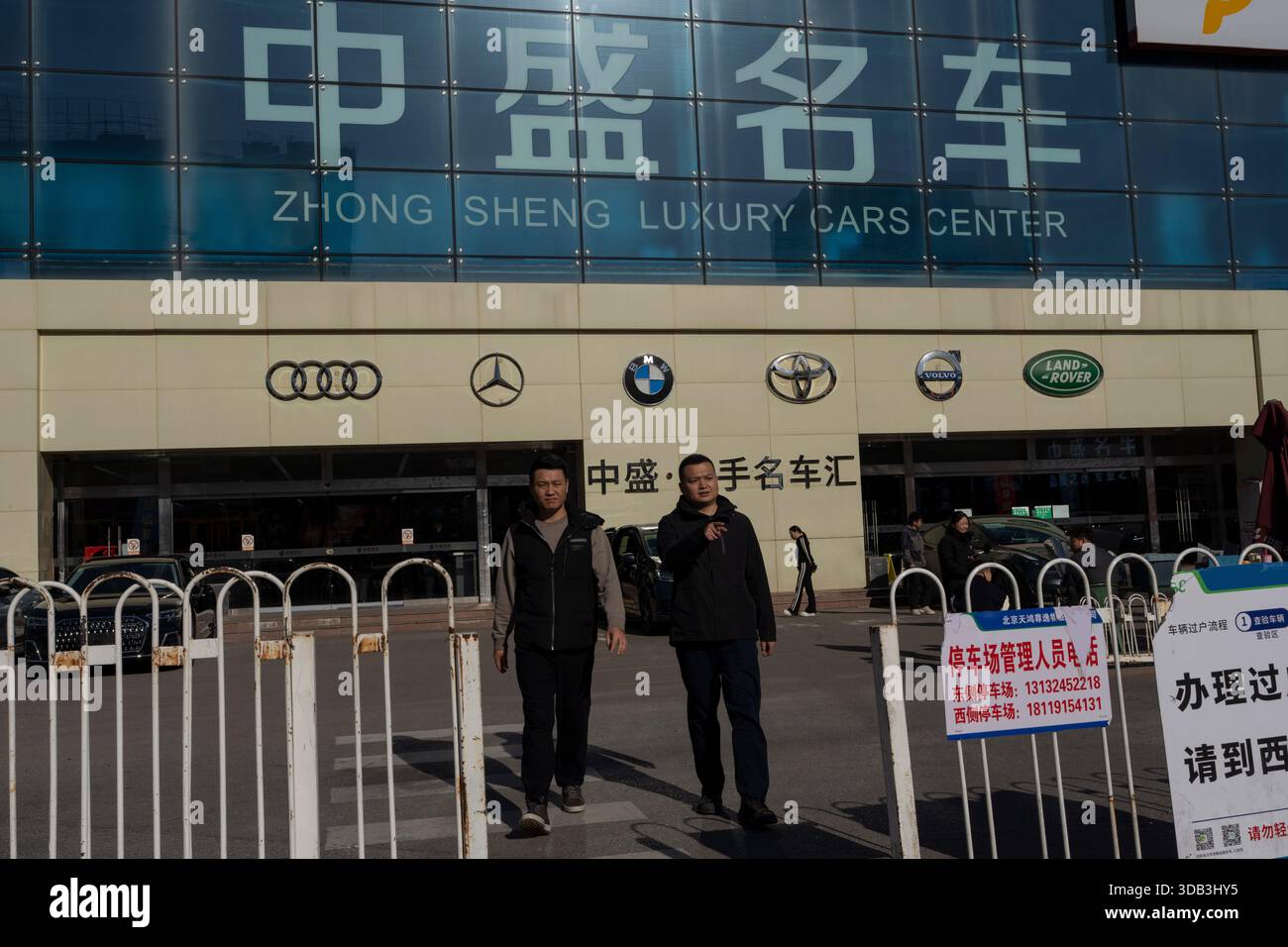 Men walk near a second hand luxury car market in Beijing on Friday, Nov ...
