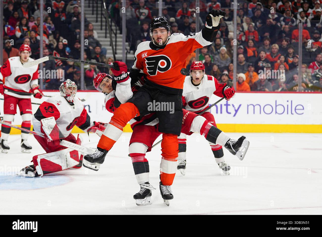 Philadelphia Flyers' Noah Cates, front, collides with Carolina ...