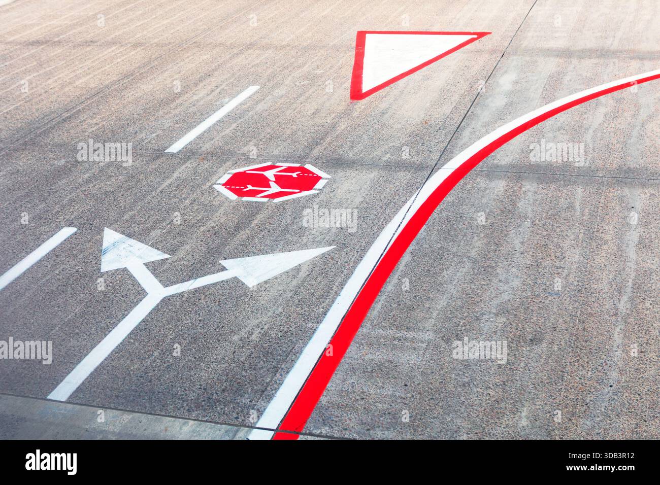 Painted guidance markings on an airport tarmac surface. Directional ...
