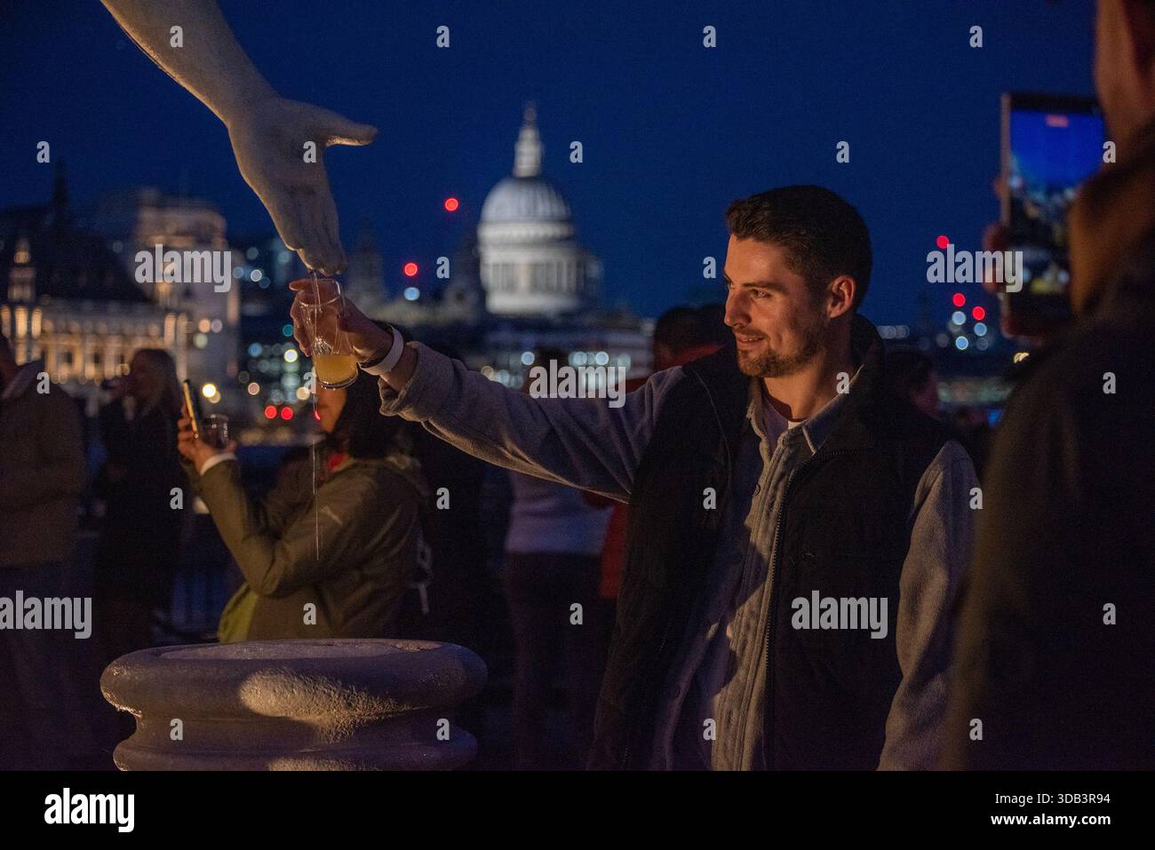 A guest fills up his glass with Peroni beer from the fountain at the ...