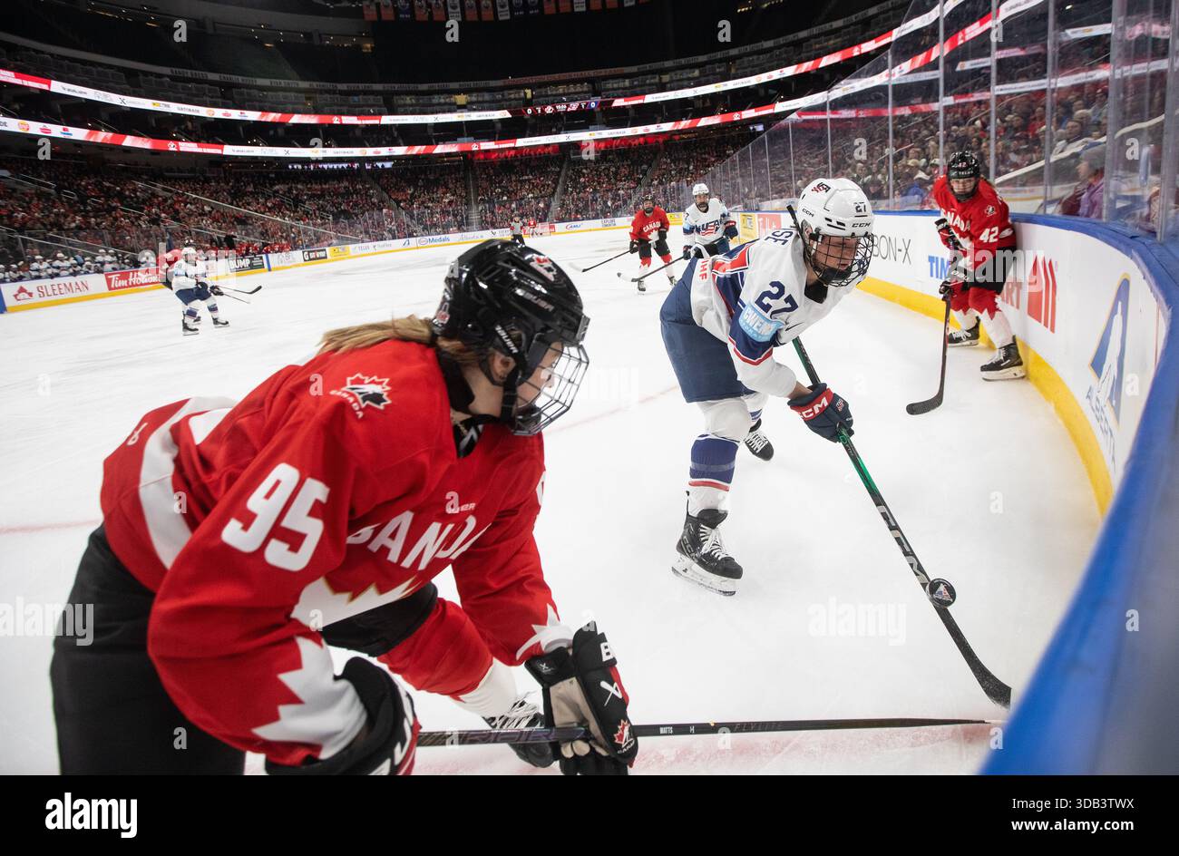 United States' Taylor Heise (27) and Canada's Daryl Watts (95) battle ...