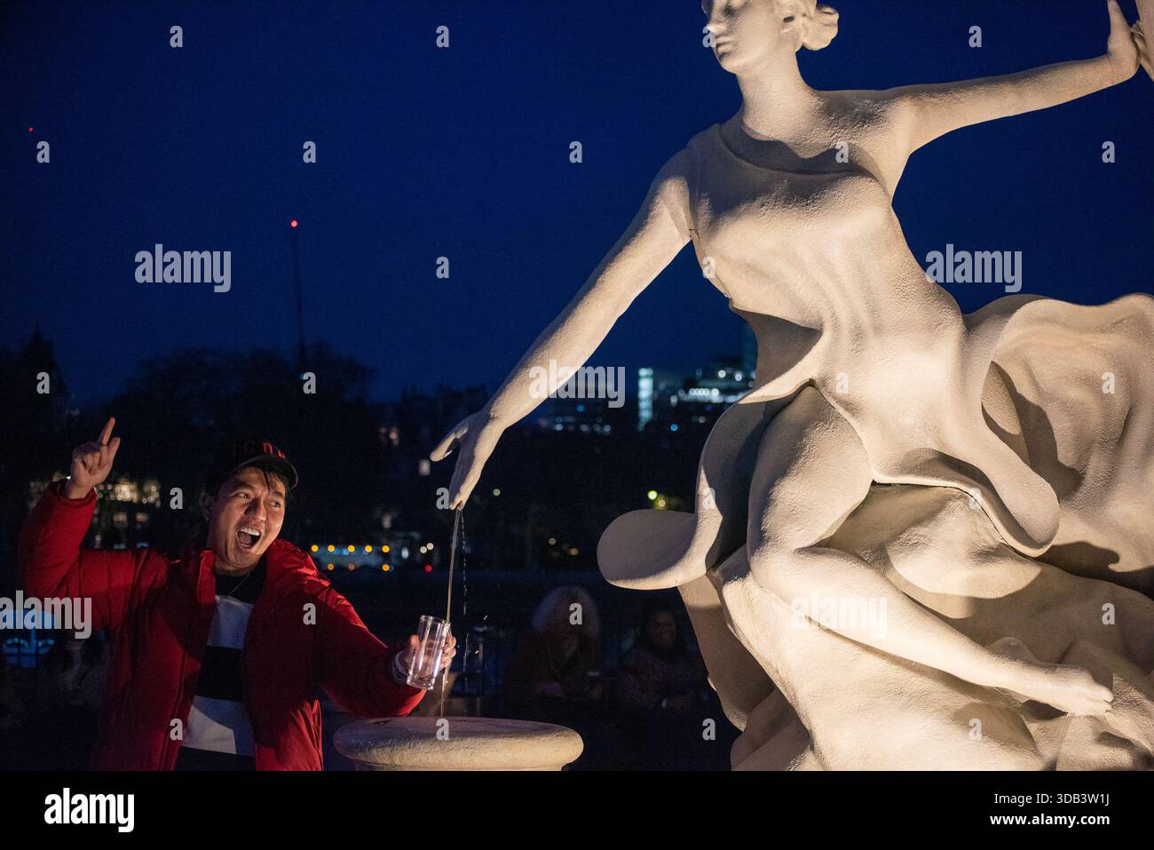 A guest happily fills up his glass with Peroni beer from the fountain ...