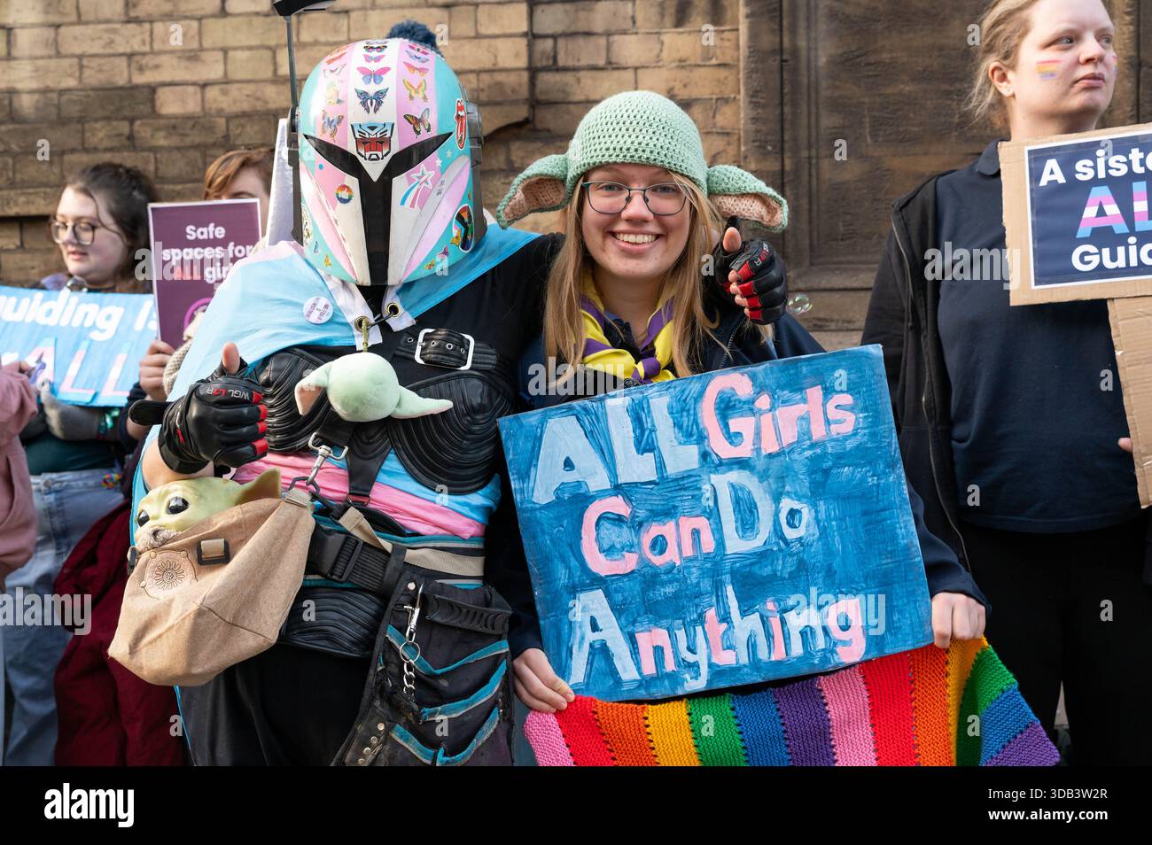 A protester holds a placard saying "All girls can do anything" during ...