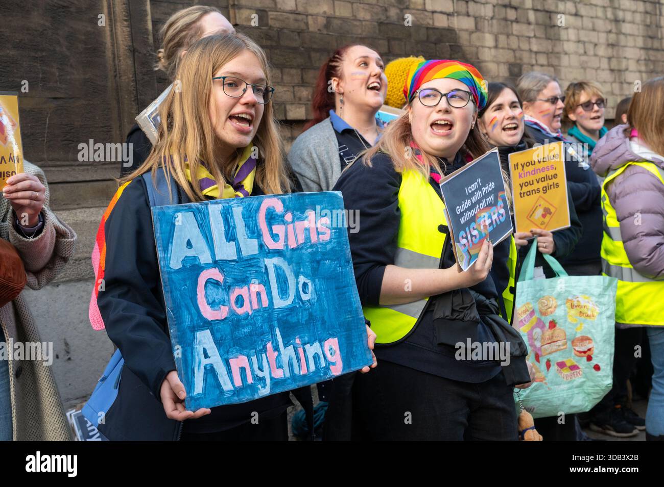 A protester holds a placard saying "All girls can do anything" during ...