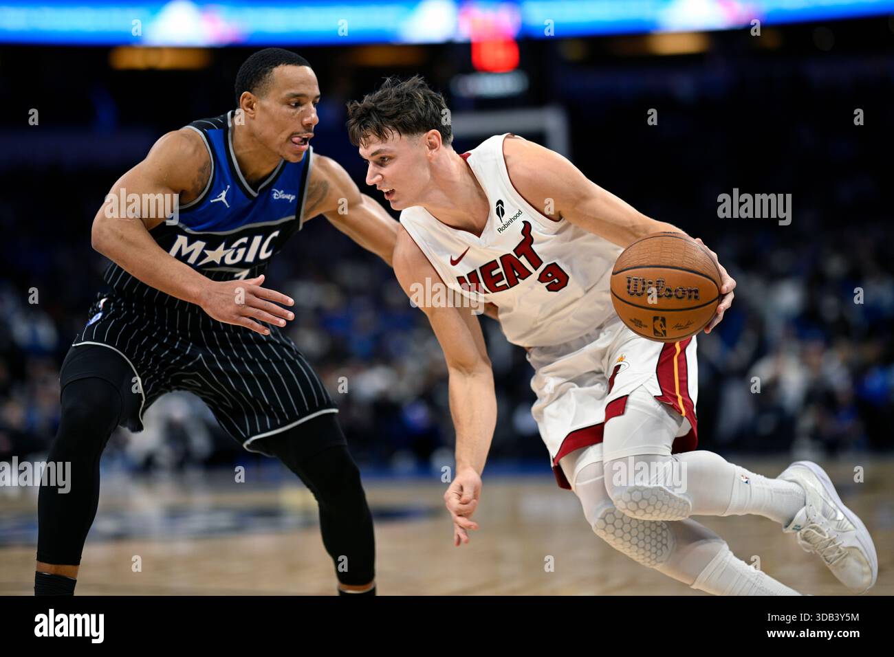 Miami Heat guard Pelle Larsson (9) is defended by Orlando Magic guard ...