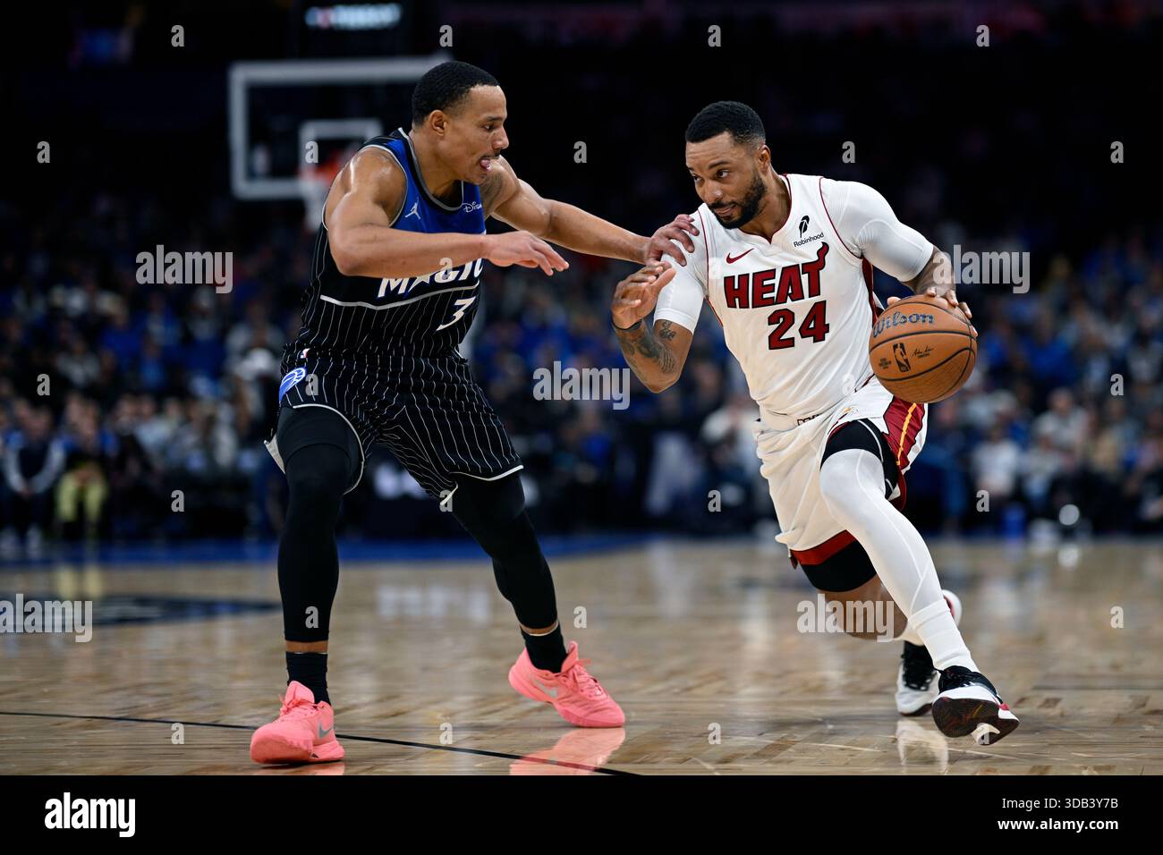 Miami Heat guard Norman Powell (24) is defended by Orlando Magic guard ...