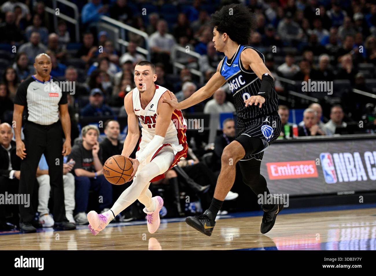 Miami Heat guard Tyler Herro, left, is defended by Orlando Magic guard ...