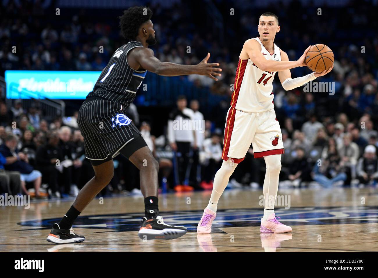 Miami Heat guard Tyler Herro (14) is defended by Orlando Magic forward ...