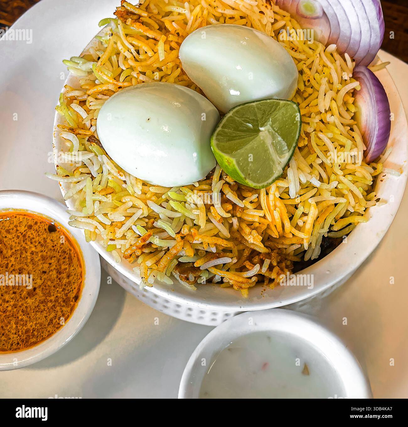 Served on a pristine white plate, the iconic Hyderabad Chicken Dum ...
