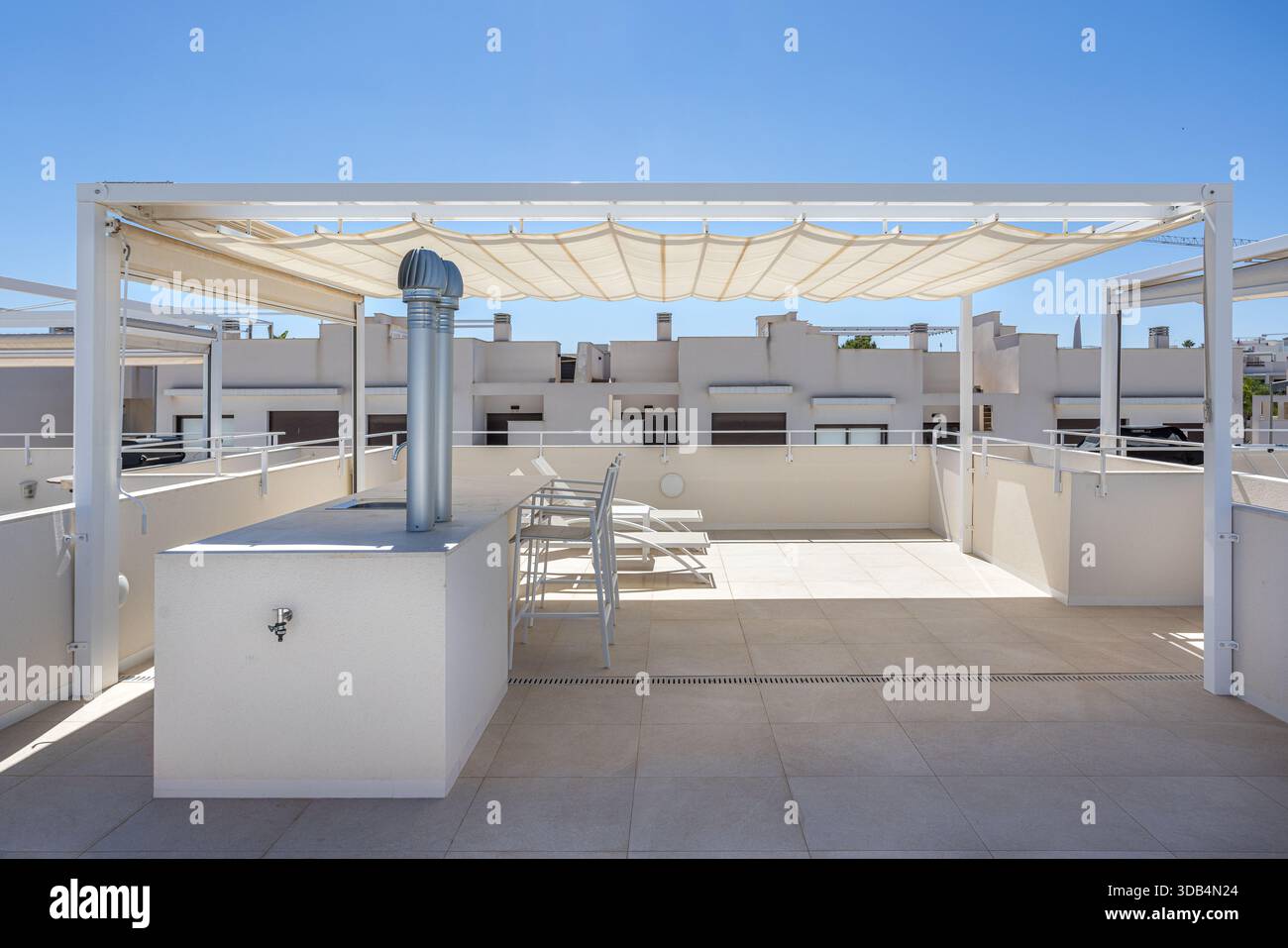 Contemporary rooftop with shade canopy, bar counter, and sunbathing ...