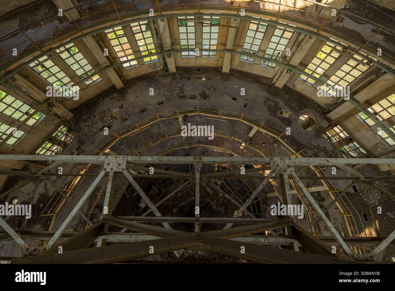 Top-down view of a circular abandoned industrial hall with rusty metal ...