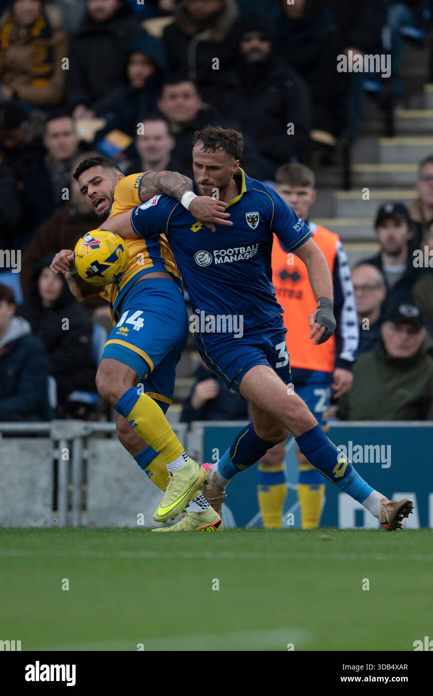 London, England. 13th Dec 2025. Mansfield Town's Dom Dwyer (left) and ...