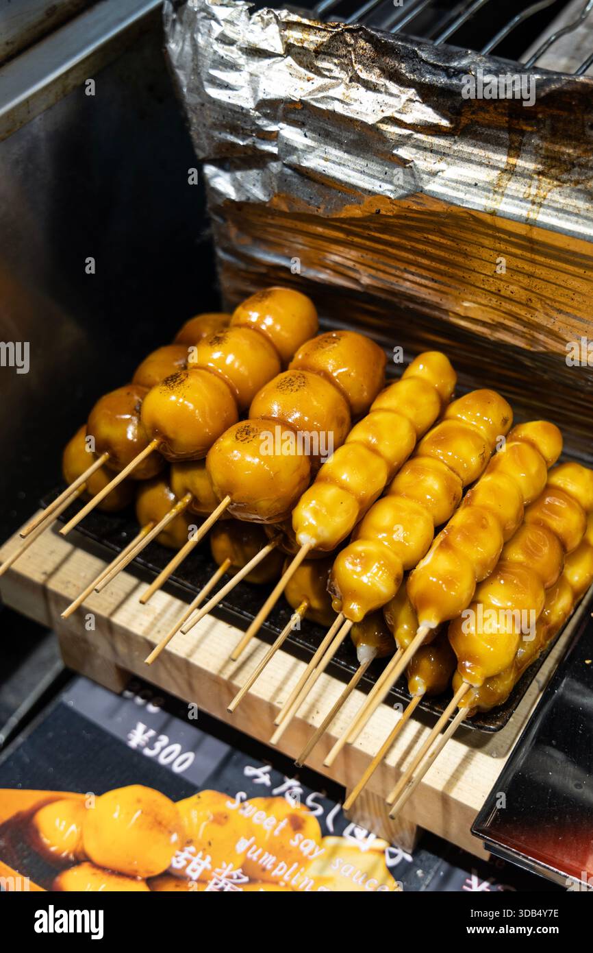 Mitarashi dango, rice dumplings with sweet soy sauce, at Kuromon Market ...