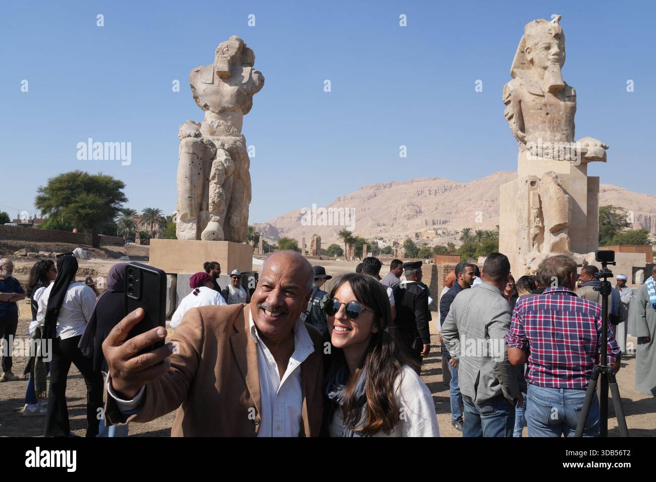 Visitors take photos with the two giant reassembled alabaster statues ...