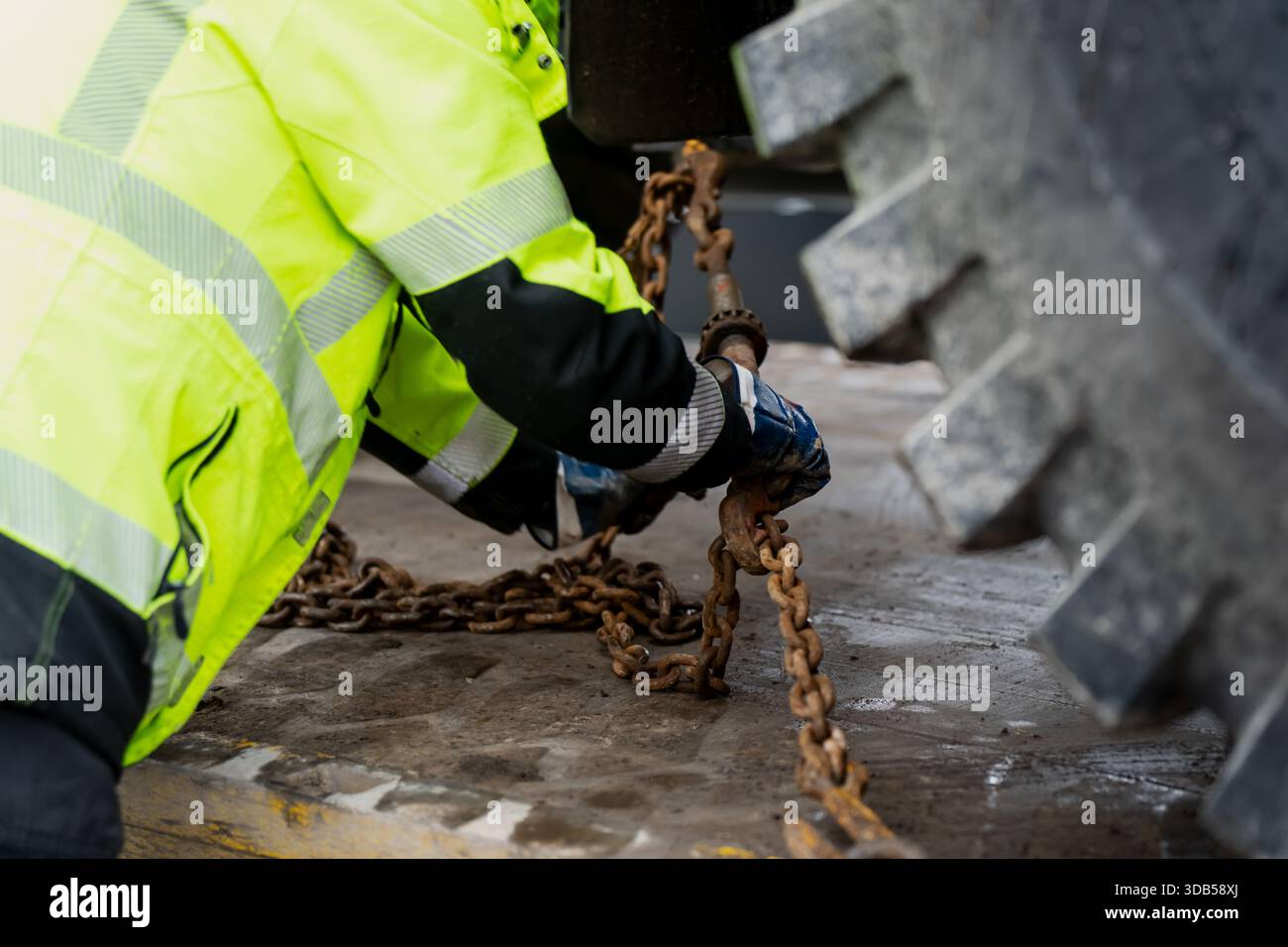 Industrial worker attaching steel chain hi-res stock photography and ...