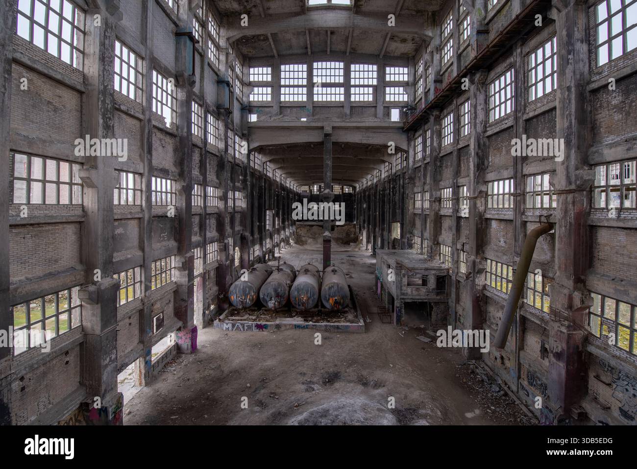 Interior of an abandoned phosphate chemical plant with rusted storage ...