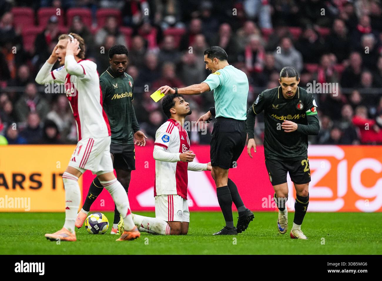 Amsterdam - Owen Wijndal of Ajax, Referee Serdar Gozubuyuk during the ...
