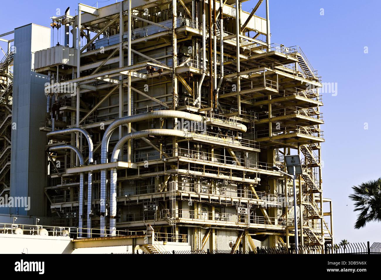 Large industrial plant with steel framework, pipes, and platforms under ...