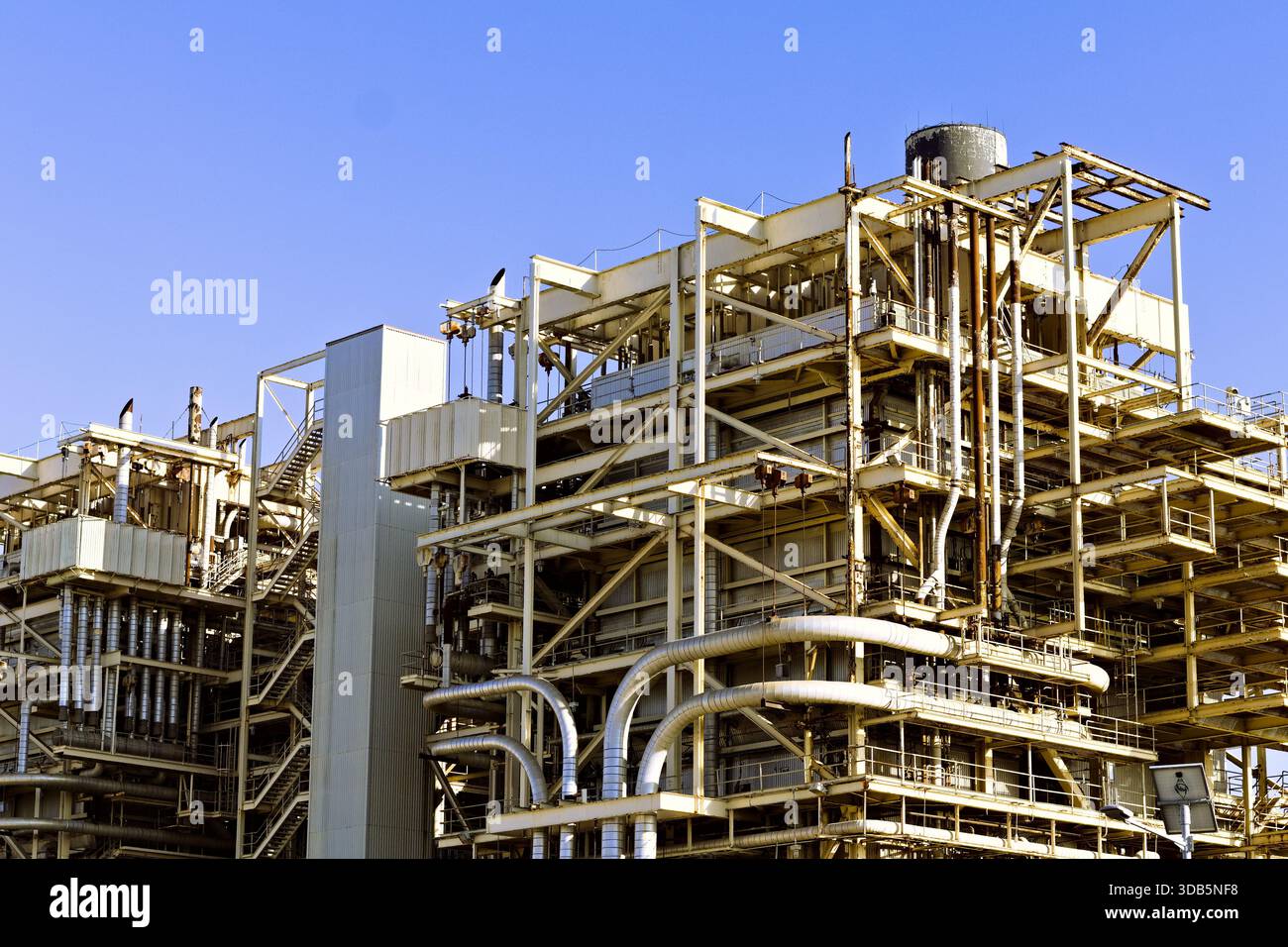 Large industrial plant with steel framework, pipes, and platforms under ...