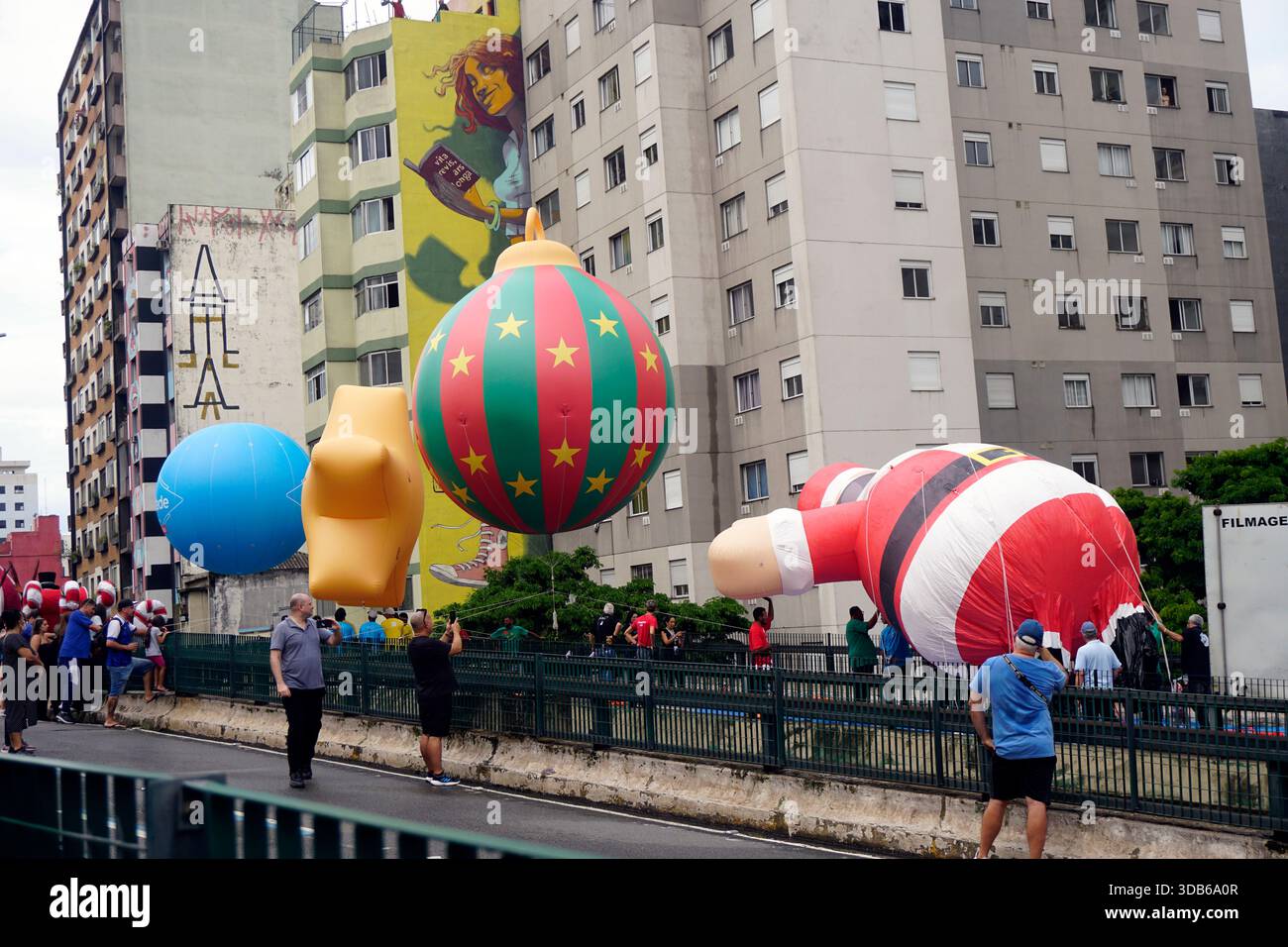 People gather to watch a Christmas parade in Sao Paulo, Brazil, 13 ...